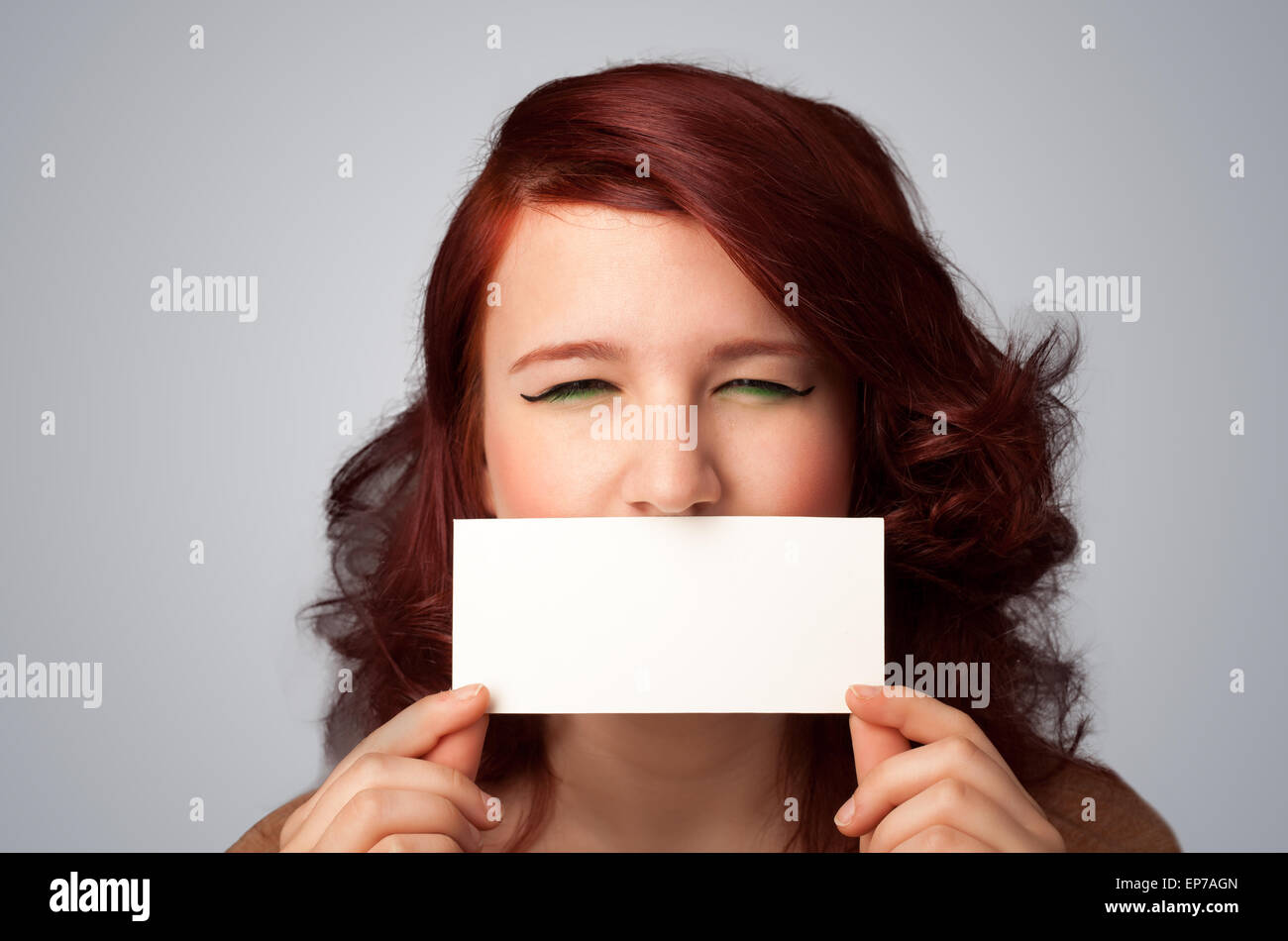 Cute girl holding white card at front of her lips with copy space Stock ...