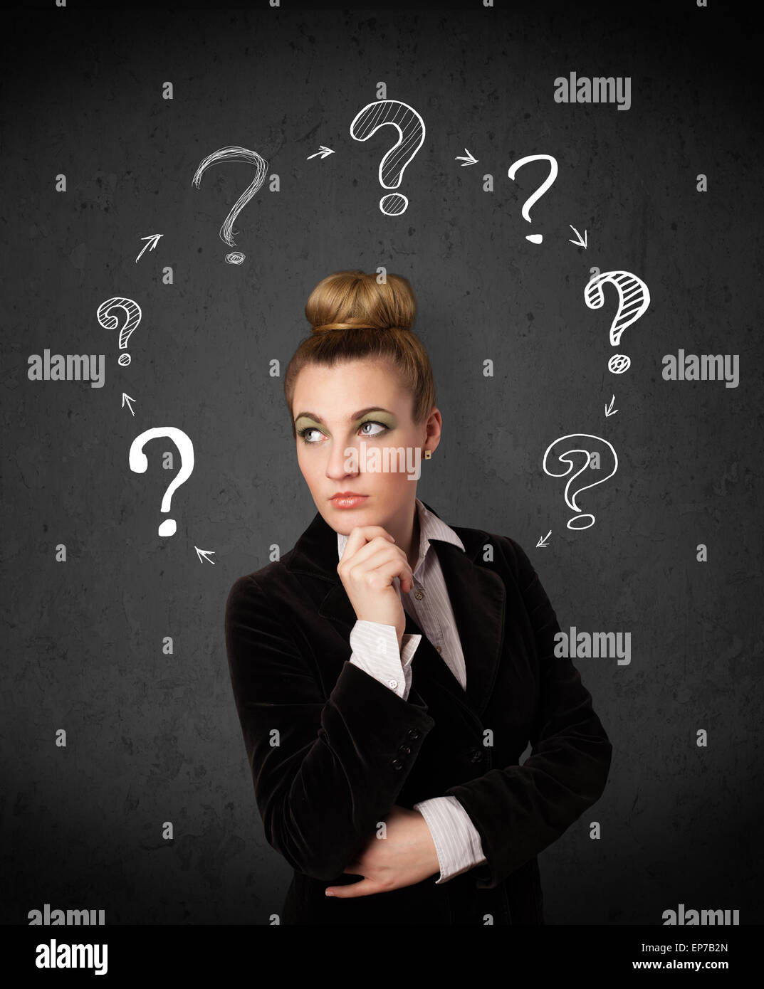 Young woman thinking with question mark circulation around her head ...