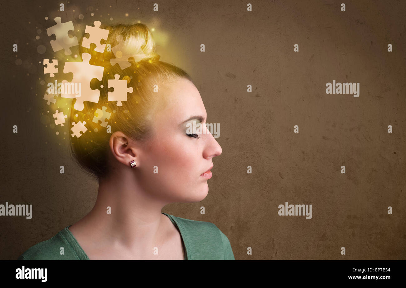 Young person thinking with glowing puzzle mind Stock Photo - Alamy