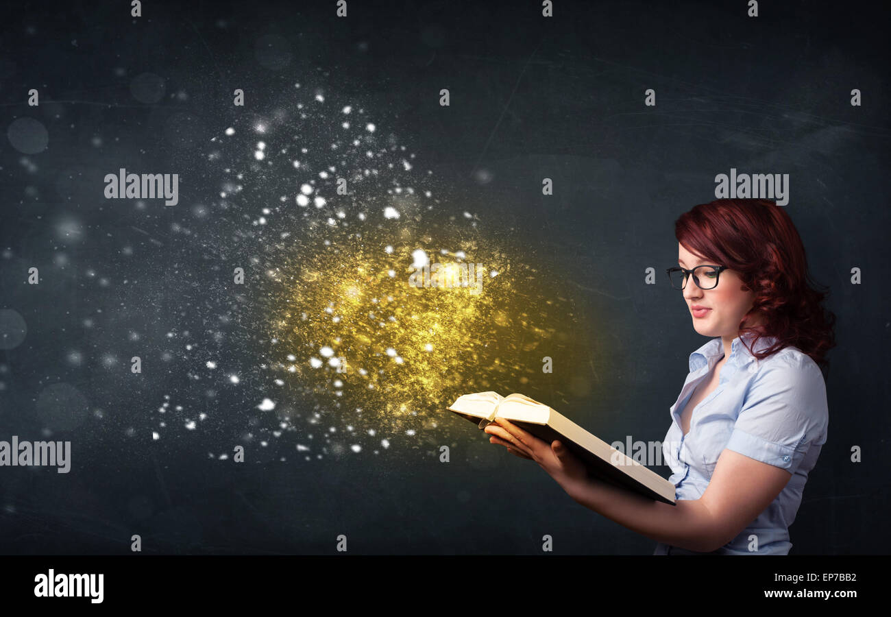 Young lady reading a magical book Stock Photo - Alamy