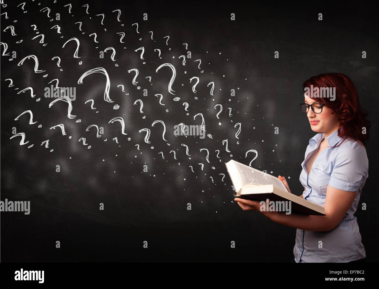 Pretty woman reading a book with question marks coming out from it ...