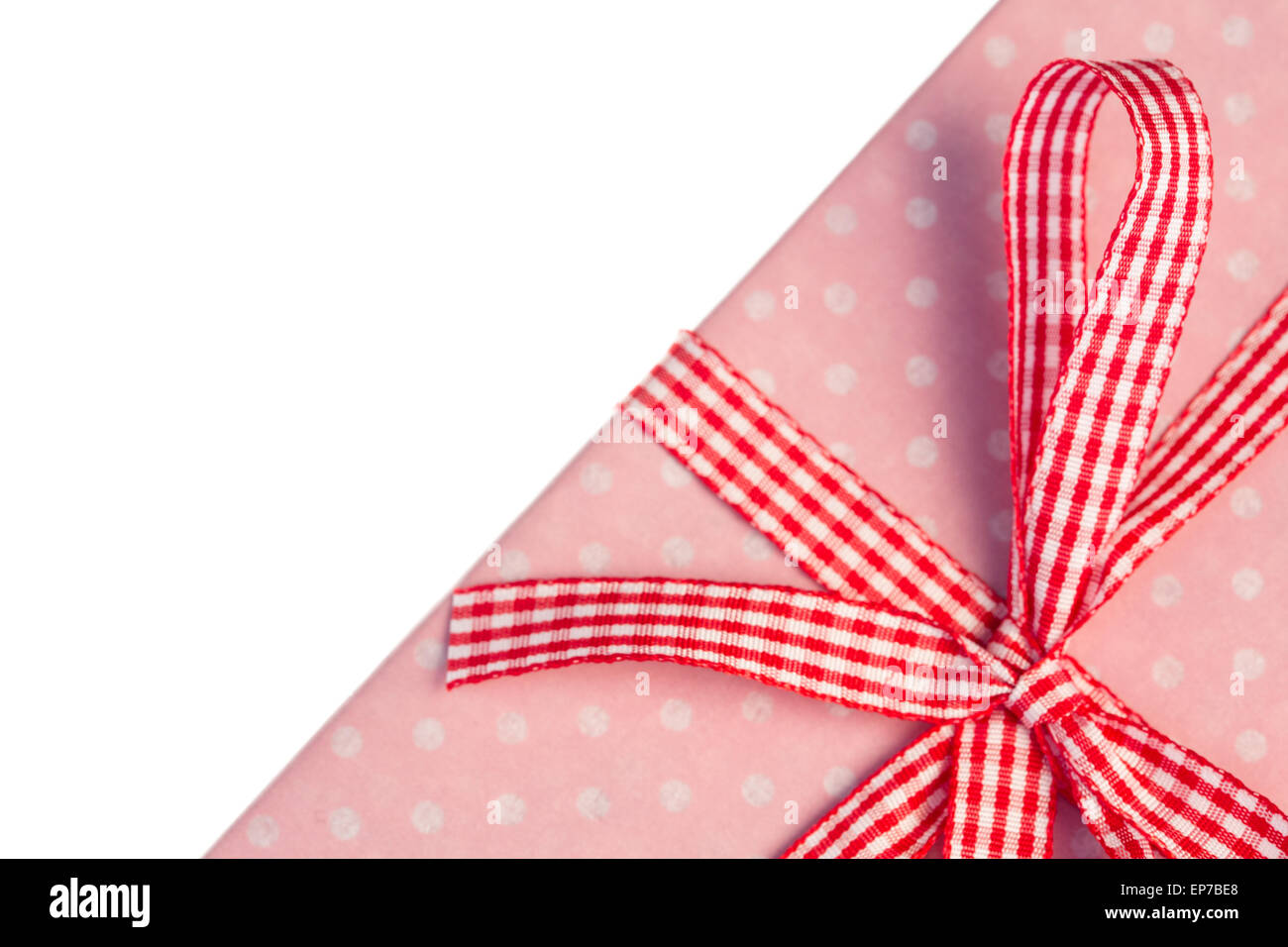 Pink gift wrapped present with gingham ribbon Stock Photo - Alamy