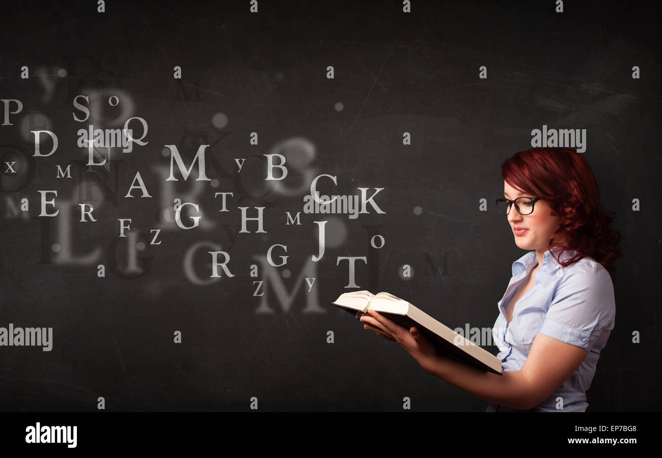 Young lady reading a book with alphabet letters Stock Photo - Alamy