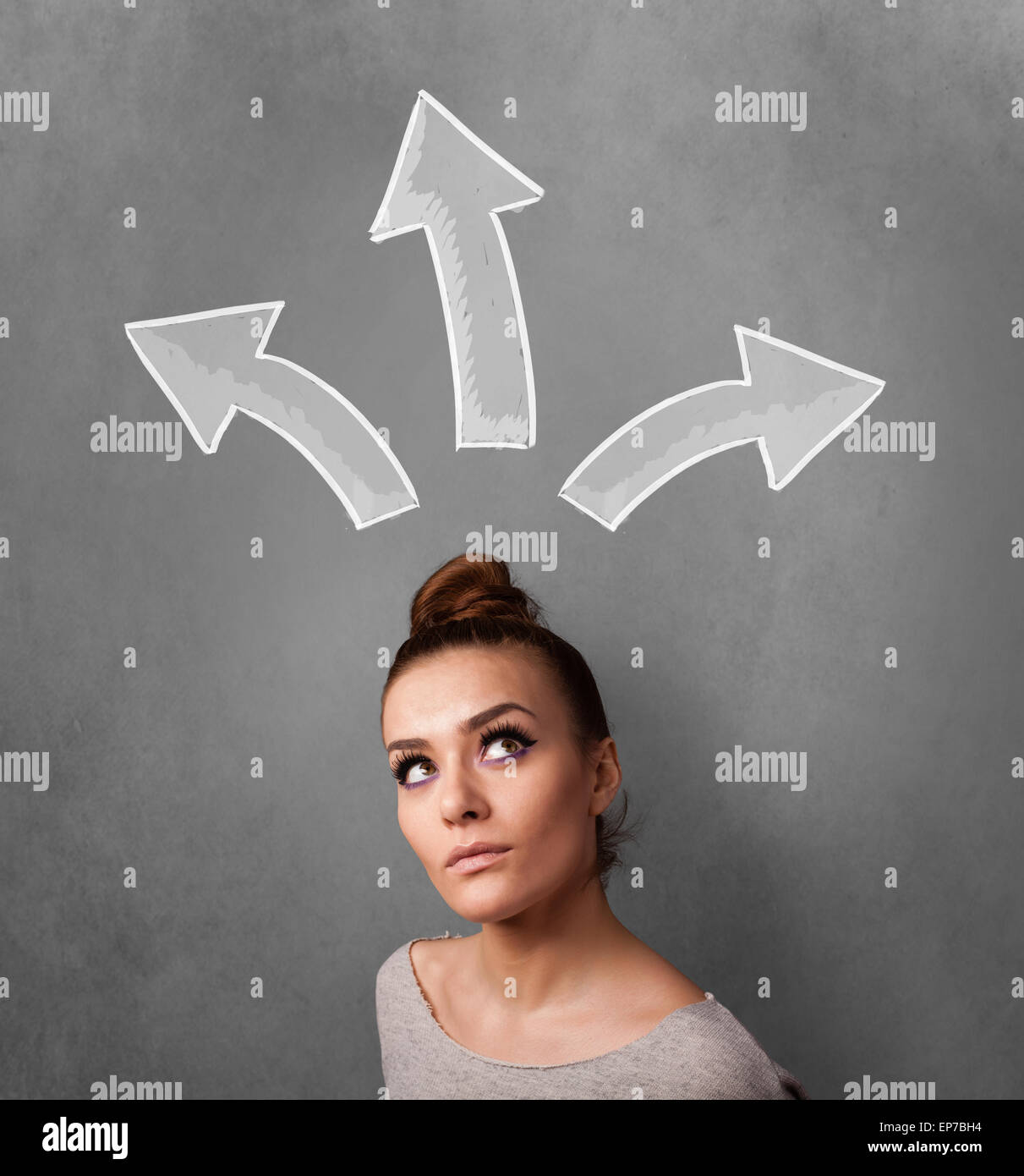 Young woman thinking with arrows above her head Stock Photo - Alamy