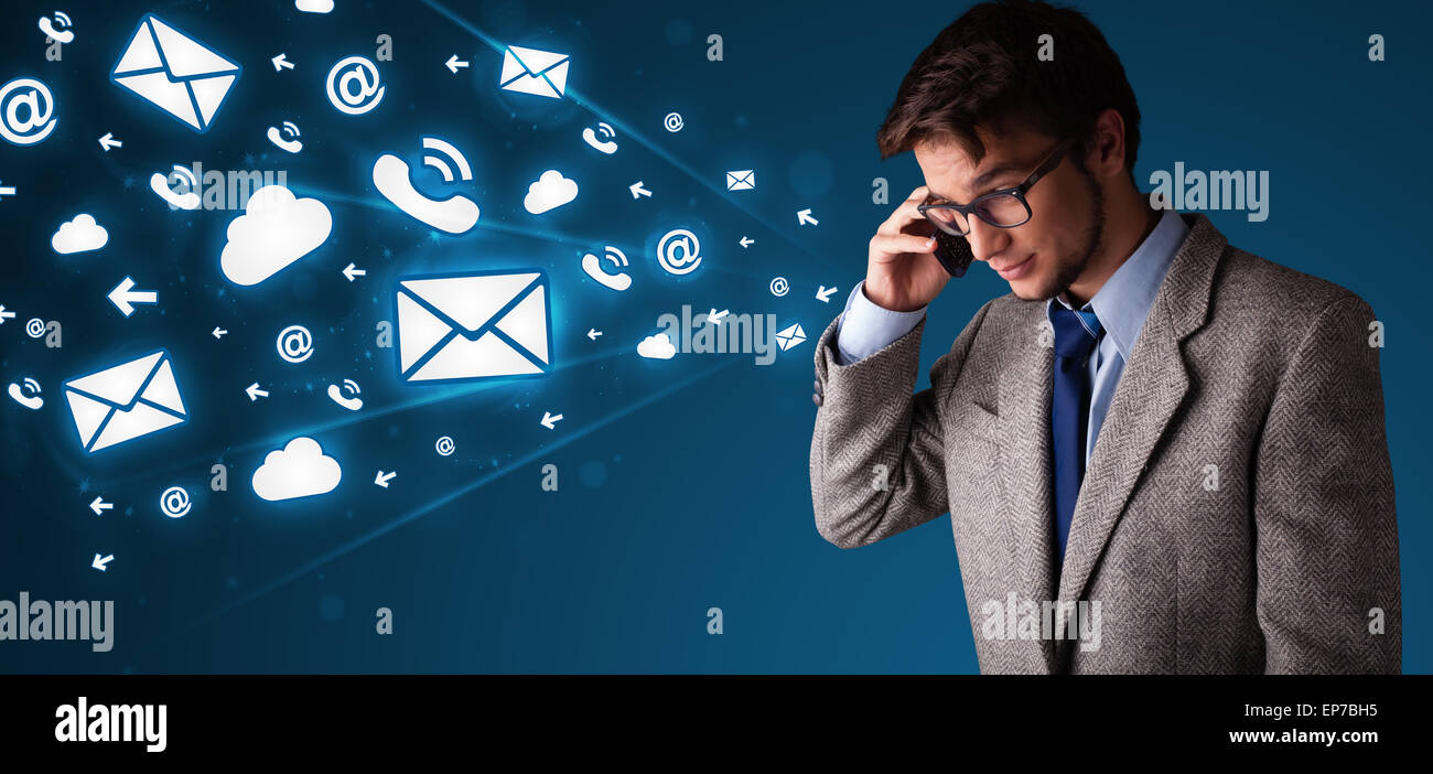 Young man making phone call with message icons Stock Photo - Alamy
