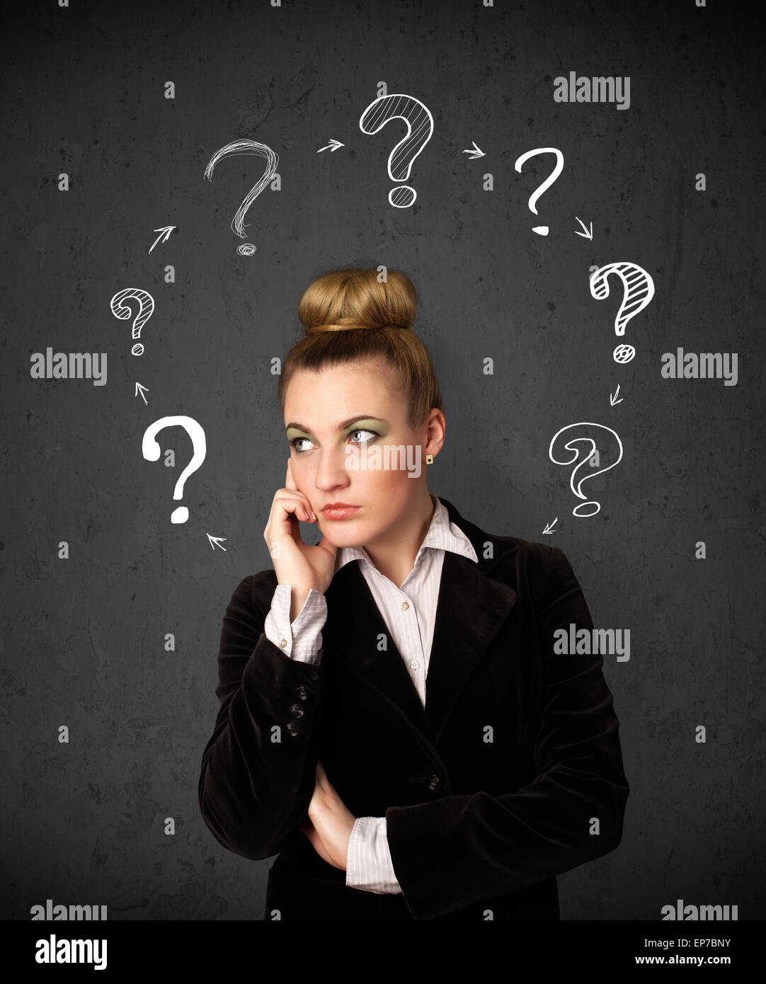 Young woman thinking with question mark circulation around her head ...