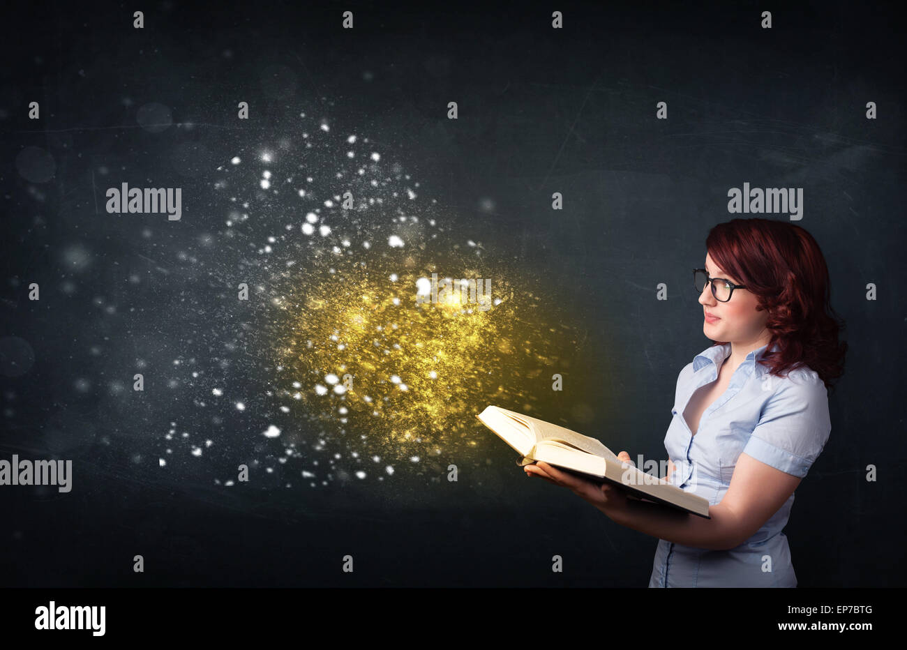 Young lady reading a magical book Stock Photo - Alamy
