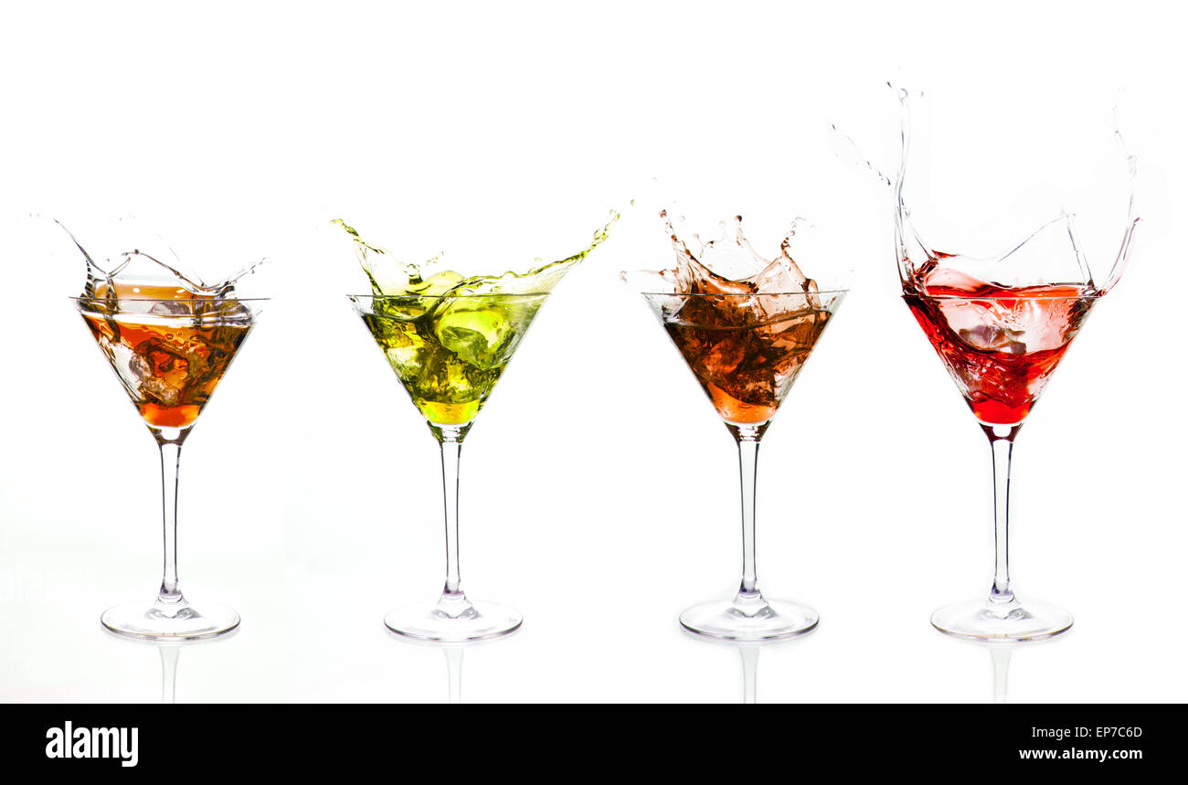 Serial arrangement of coloured liquids splashing in cocktail glass ...