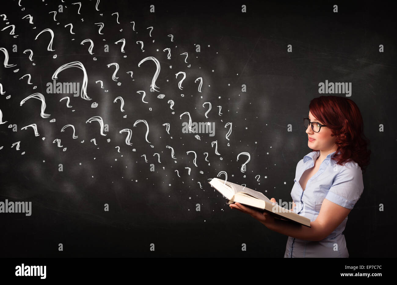 Pretty woman reading a book with question marks coming out from it ...