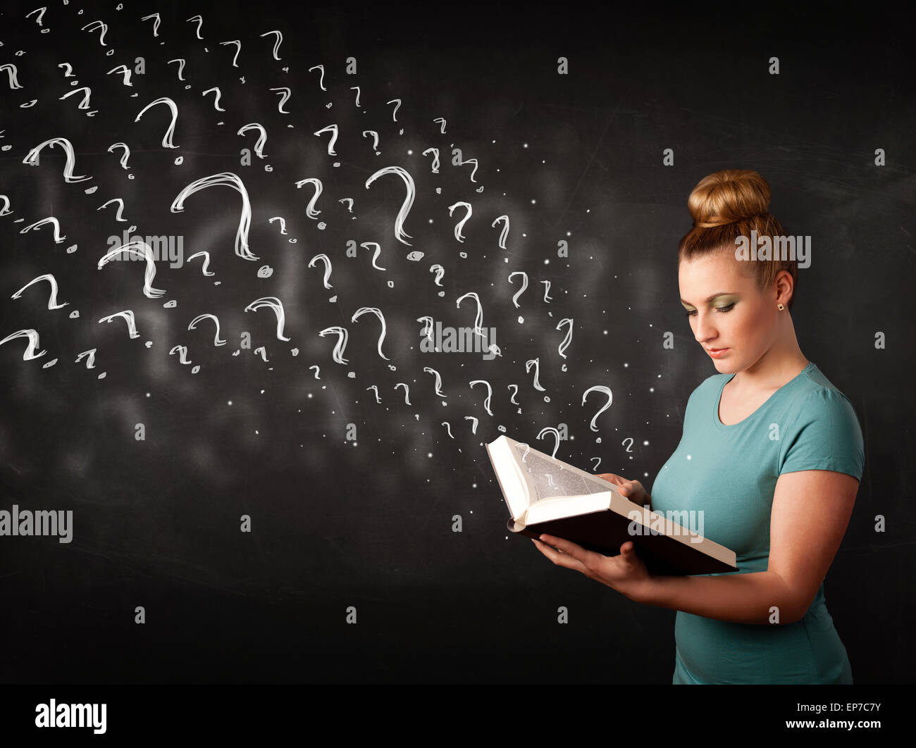 Pretty woman reading a book with question marks coming out from it ...
