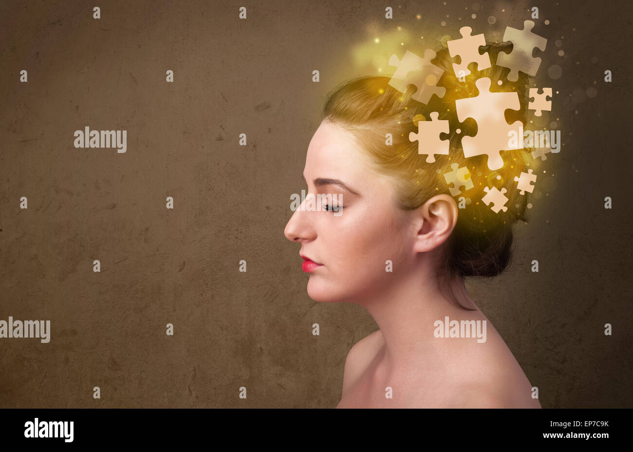 Young person thinking with glowing puzzle mind Stock Photo - Alamy