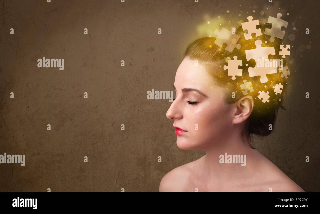 Young person thinking with glowing puzzle mind Stock Photo - Alamy