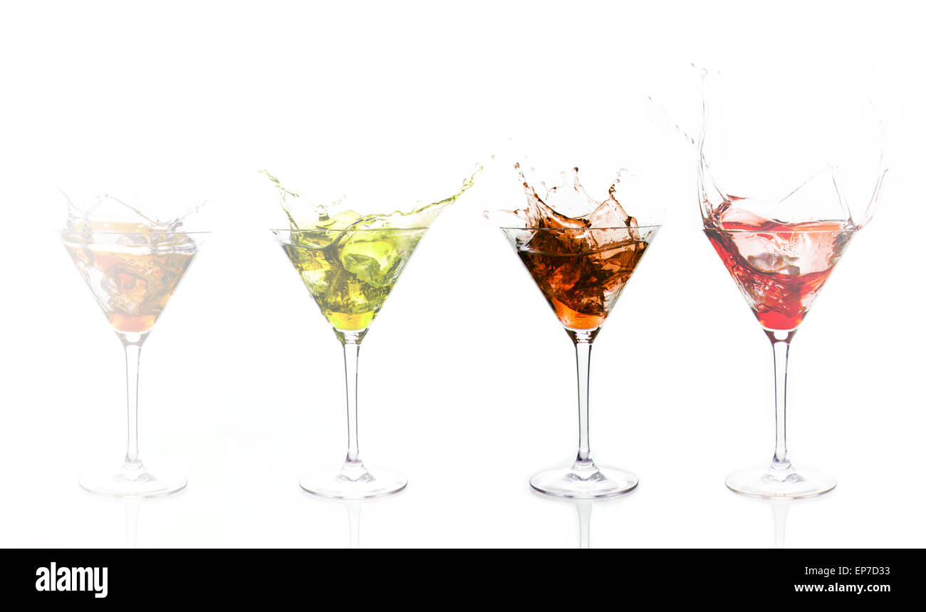 Serial arrangement of coloured alcohol splashing in cocktail glass ...