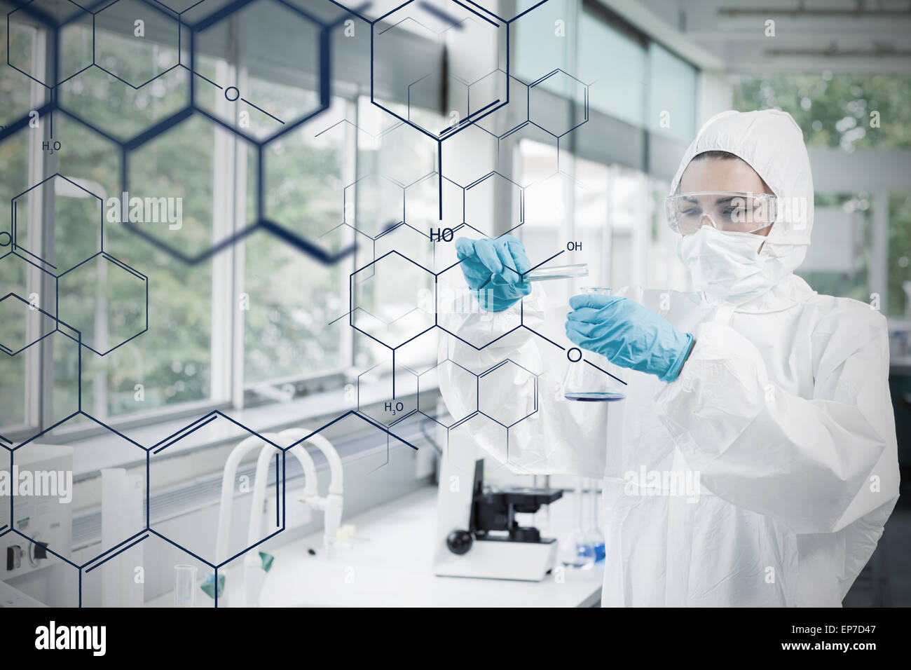 Chemist in protective suit working with futuristic interface with ...