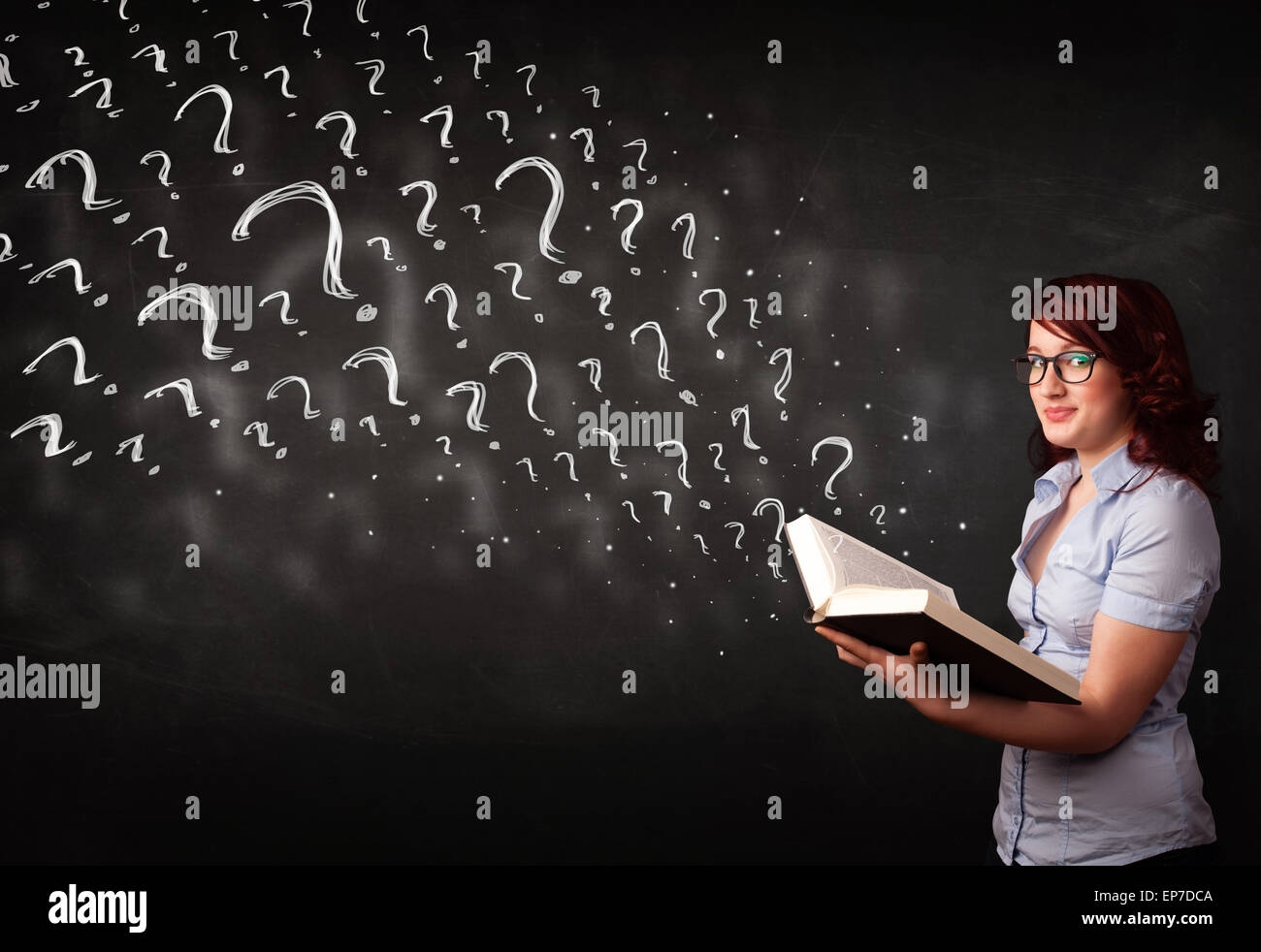 Pretty woman reading a book with question marks coming out from it ...