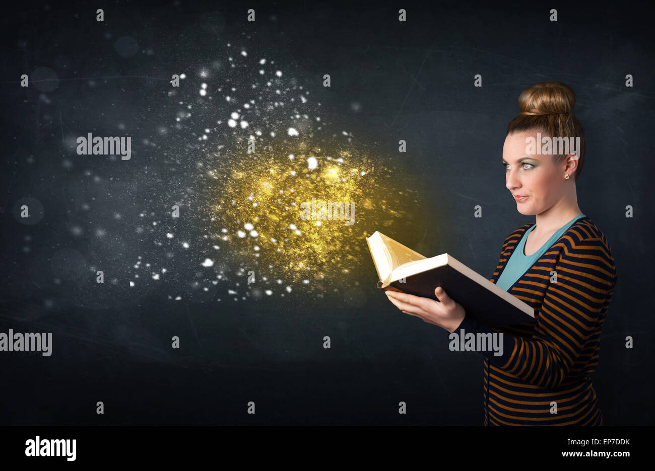 Young lady reading a magical book Stock Photo - Alamy