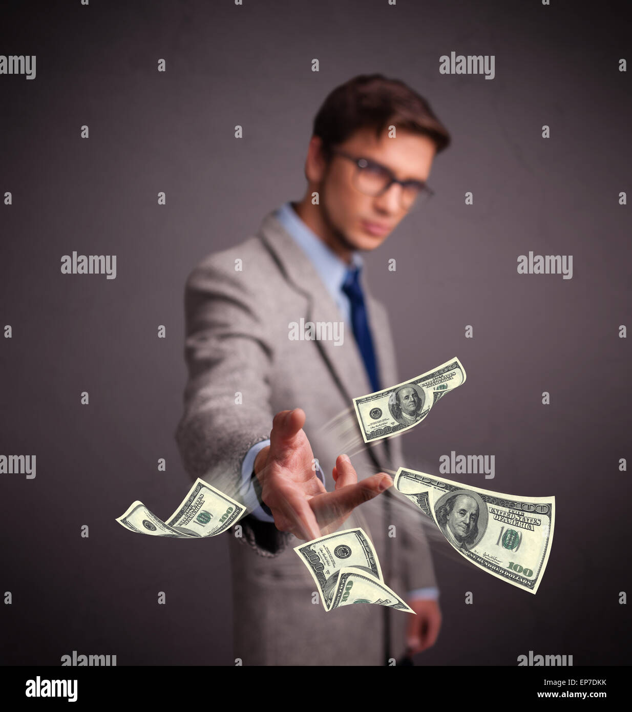 Young man throwing money Stock Photo - Alamy