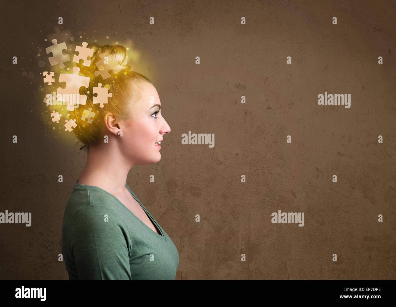 Young person thinking with glowing puzzle mind Stock Photo - Alamy