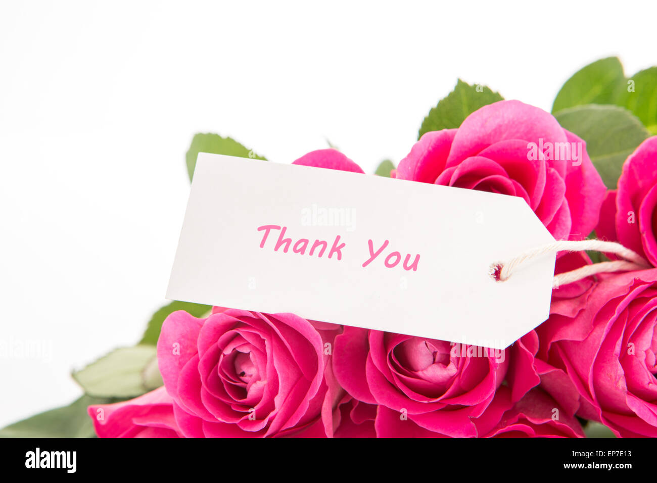 Close up of a beautiful bouquet of pink roses with a thank you card on ...