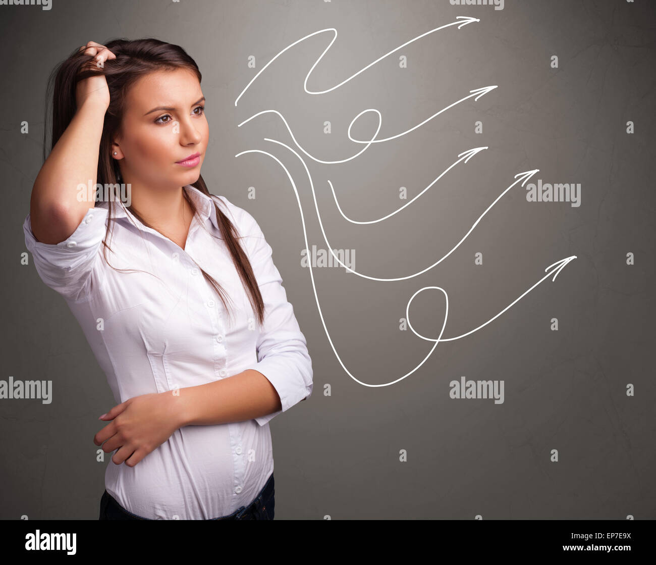 Attractive teenager looking at multiple curly arrows Stock Photo - Alamy