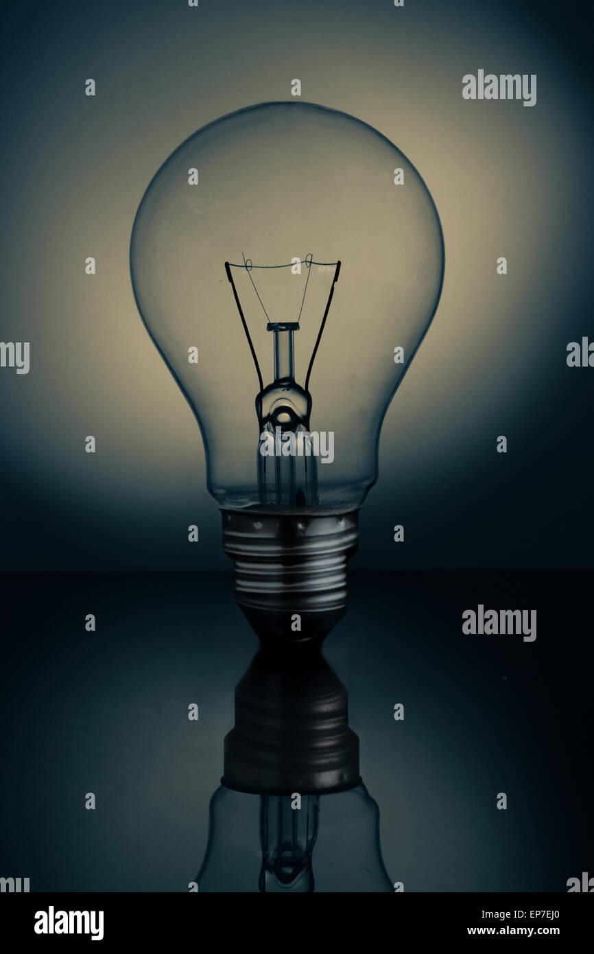 Big clear light bulb standing on reflective surface Stock Photo - Alamy