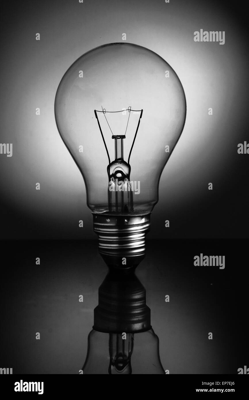 Big clear light bulb standing in black and white Stock Photo - Alamy