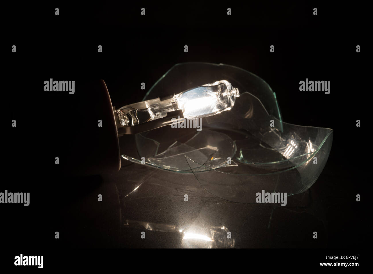 Glass of clear light bulb broken on black background Stock Photo - Alamy