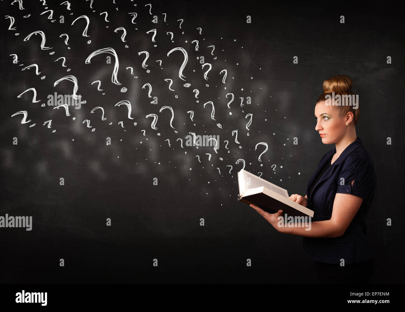 Pretty woman reading a book with question marks coming out from it ...
