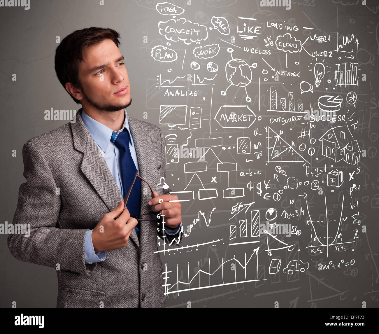 Attractive man looking at stock market graphs and symbols Stock Photo ...