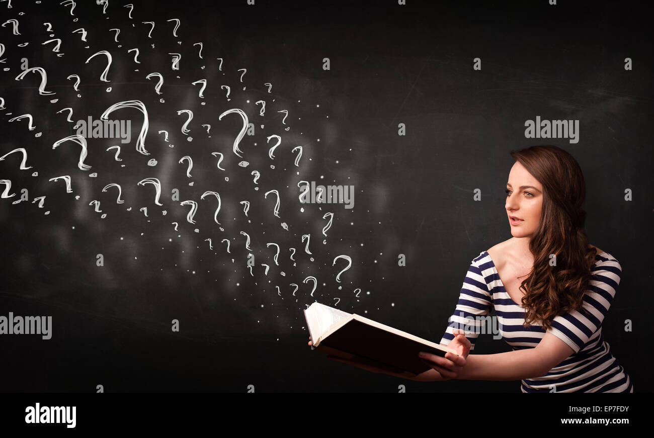 Pretty woman reading a book with question marks coming out from it ...