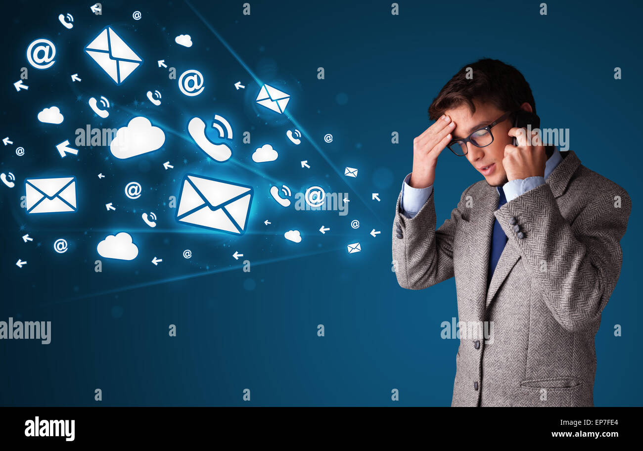 Young man making phone call with message icons Stock Photo - Alamy