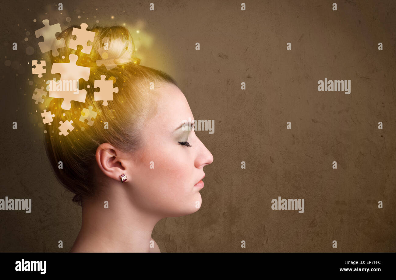 Young person thinking with glowing puzzle mind Stock Photo - Alamy