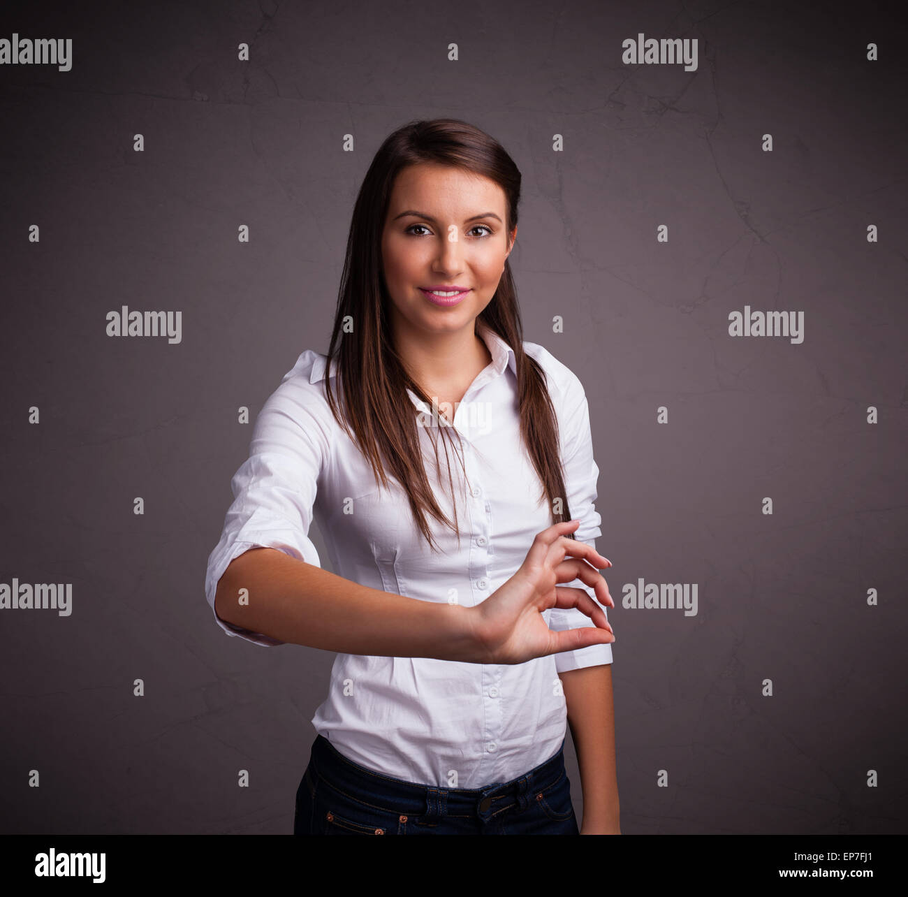 Pretty girl holding something Stock Photo - Alamy