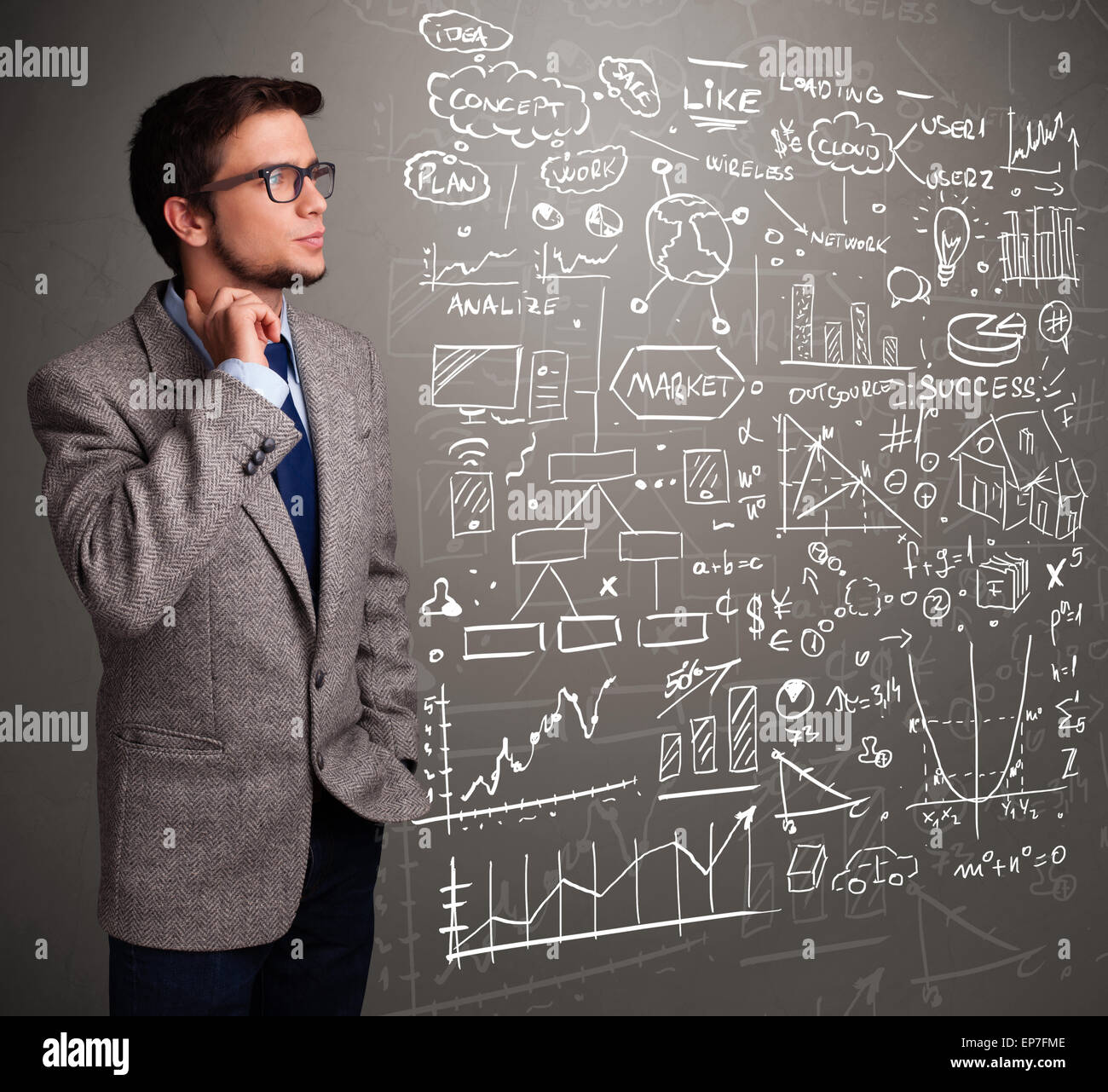 Attractive man looking at stock market graphs and symbols Stock Photo ...