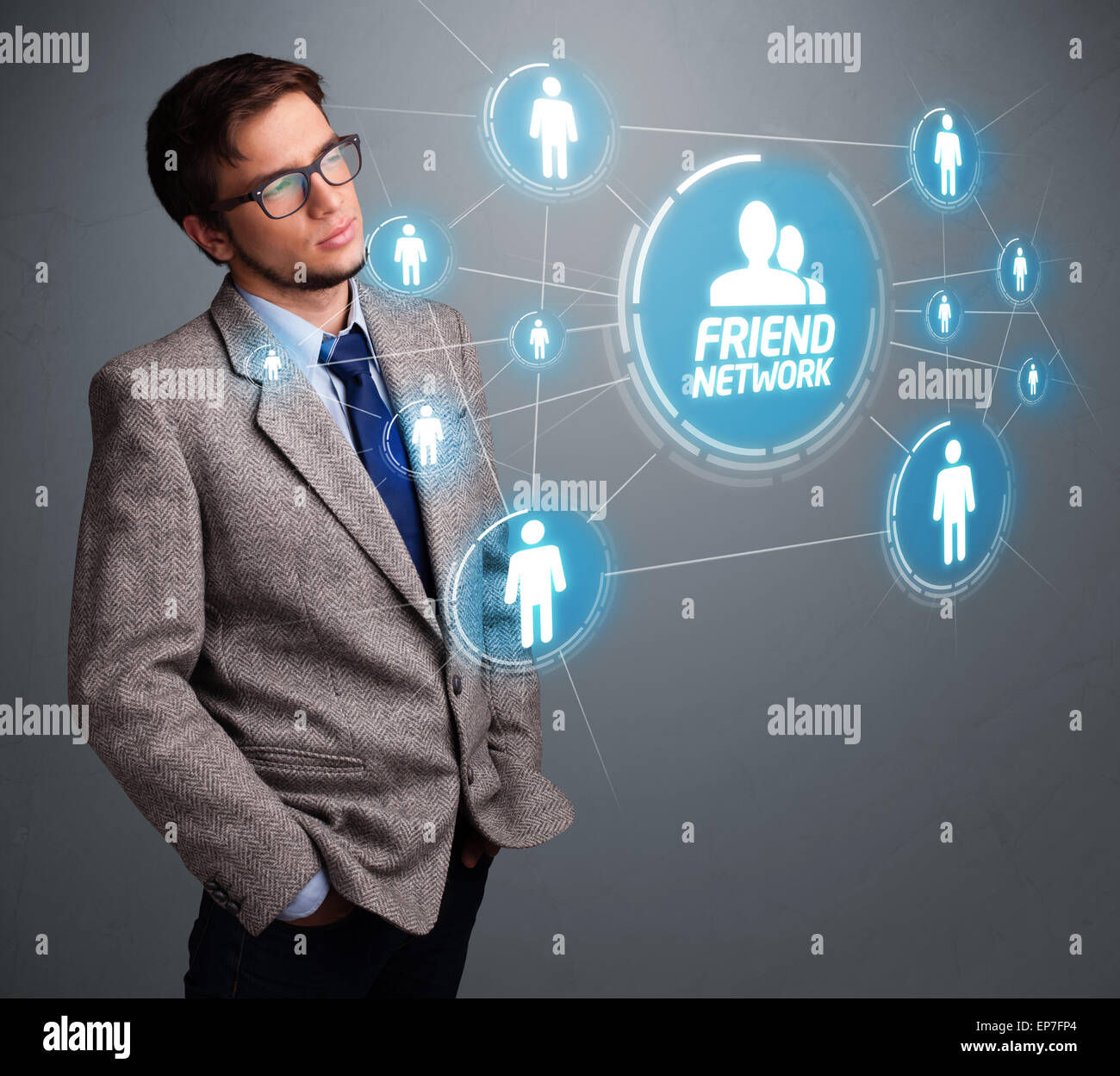 Handsome man looking at modern social network Stock Photo - Alamy