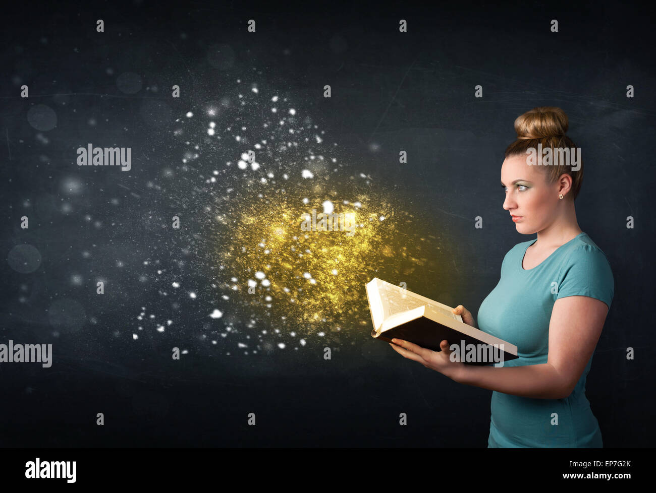 Young lady reading a magical book Stock Photo - Alamy