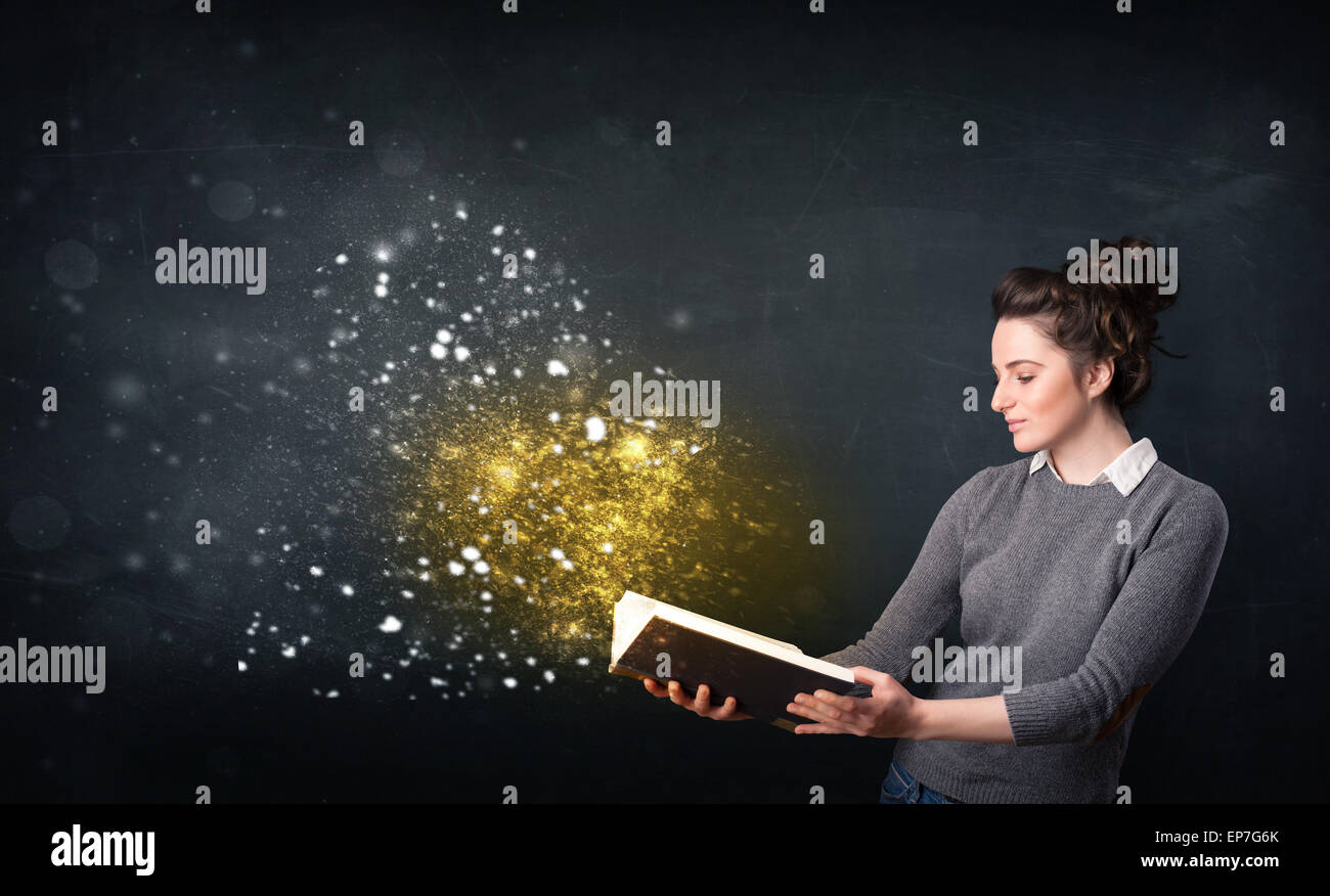 Young lady reading a magical book Stock Photo - Alamy