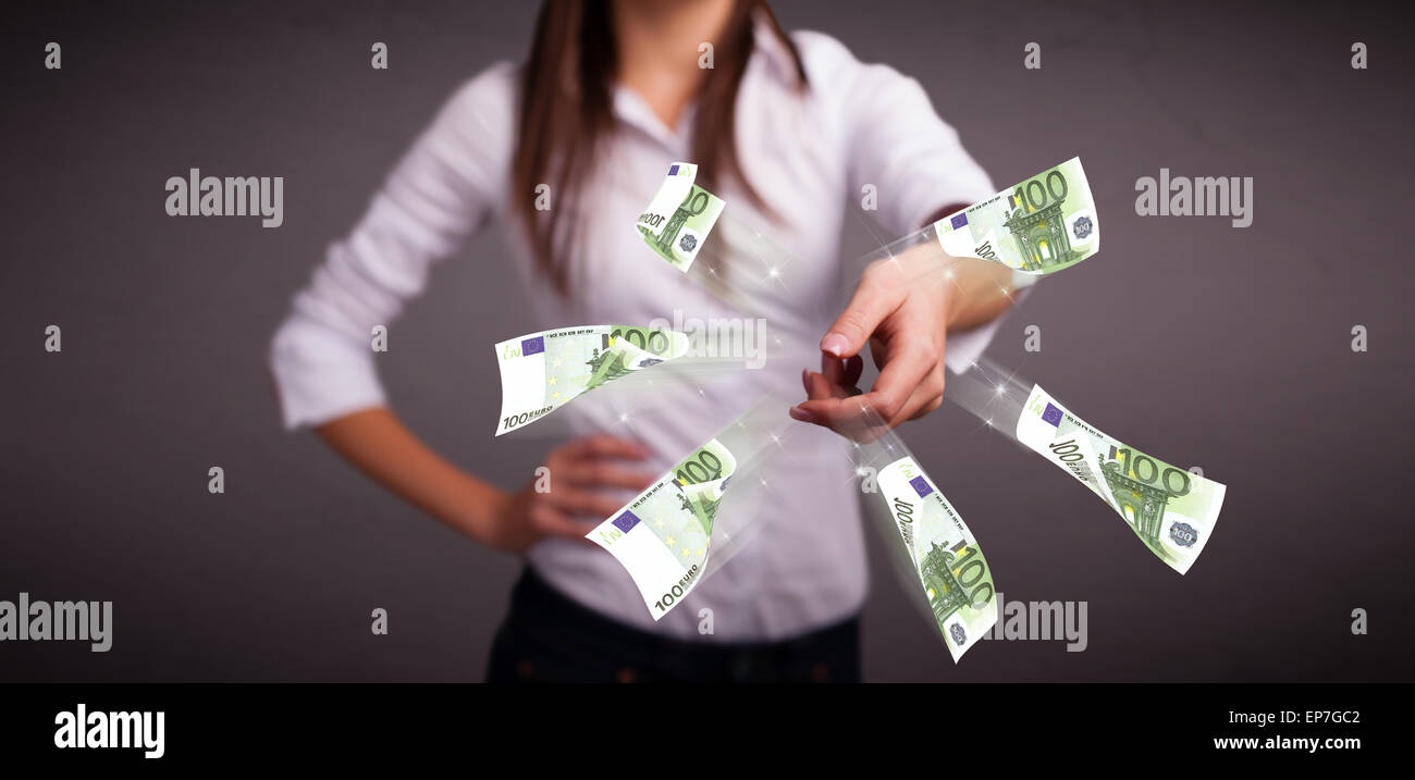 Pretty woman standing and throwing money Stock Photo - Alamy