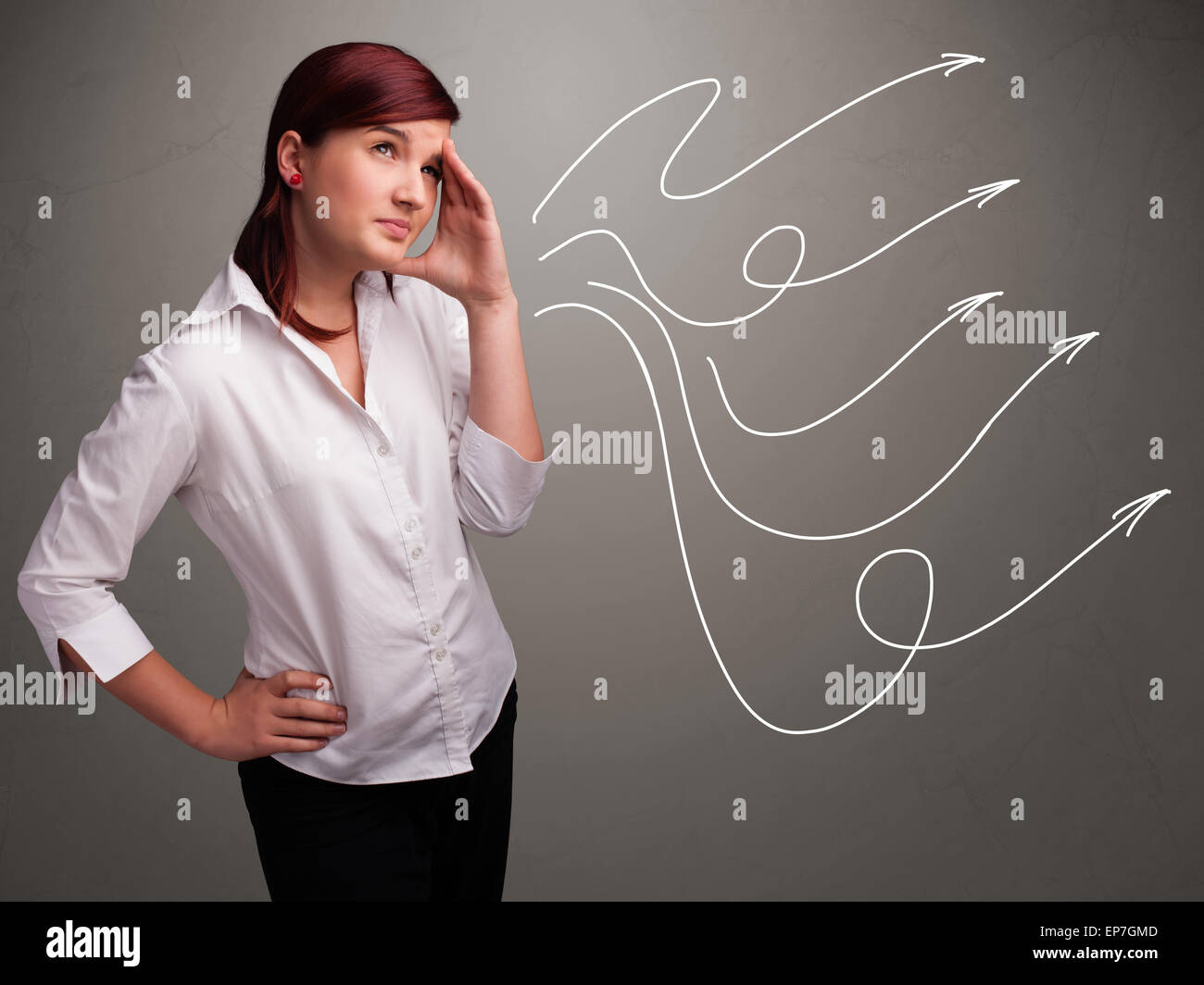 Attractive teenager looking at multiple curly arrows Stock Photo - Alamy
