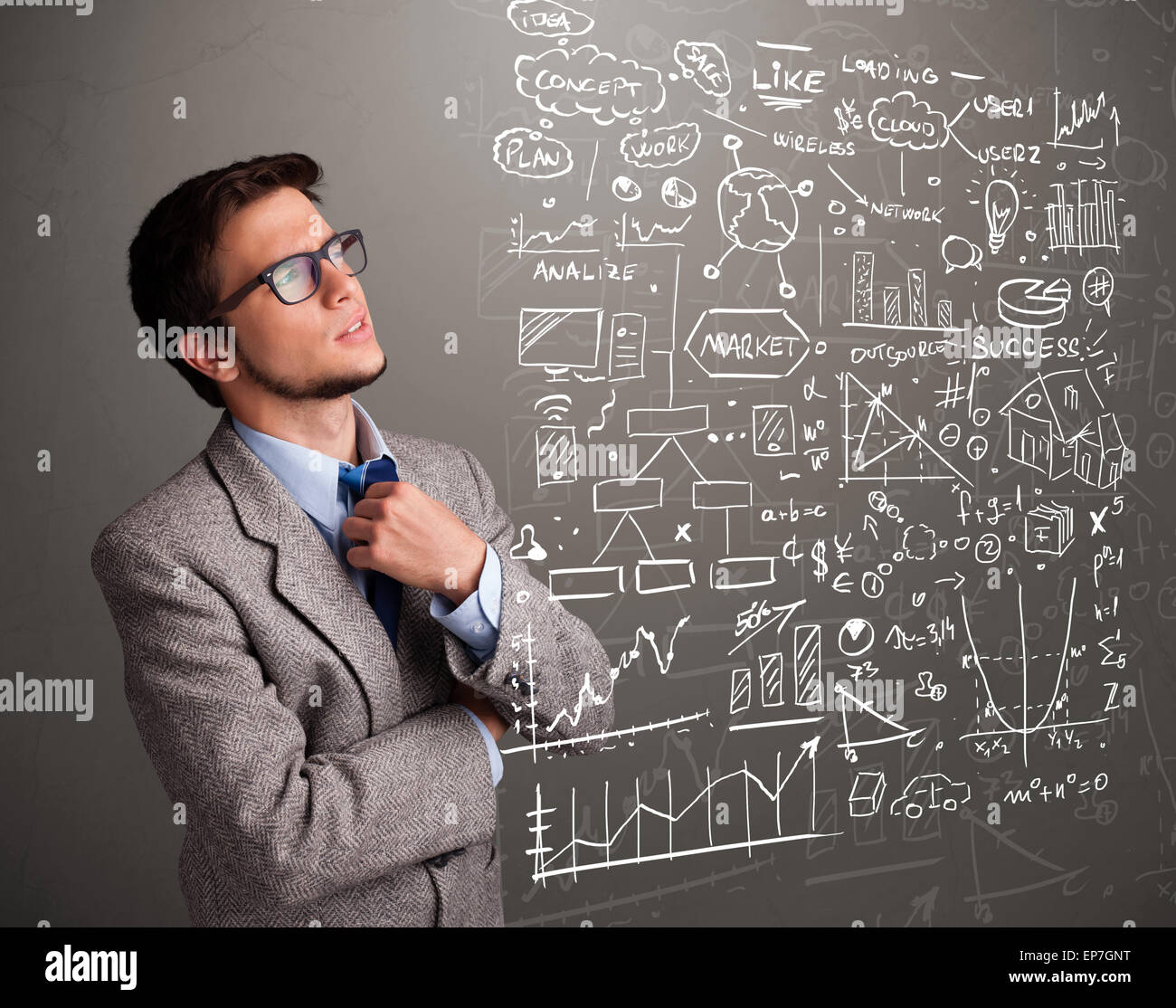 Attractive man looking at stock market graphs and symbols Stock Photo ...