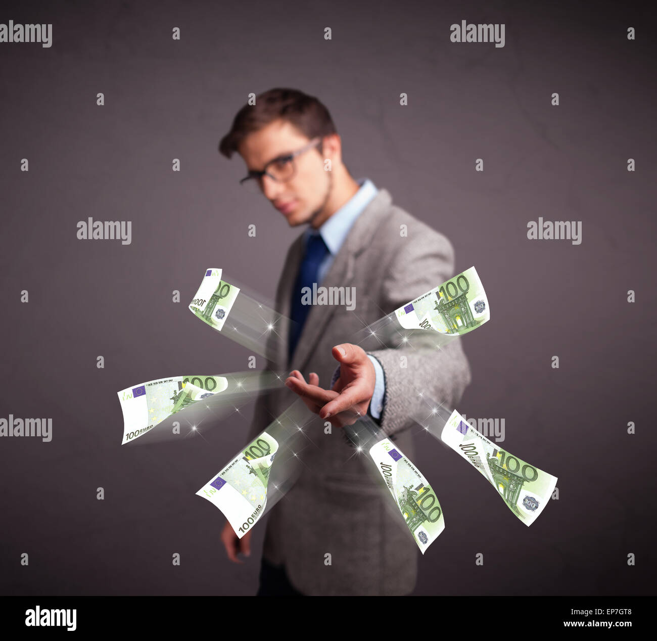 Young man standing and throwing money Stock Photo - Alamy