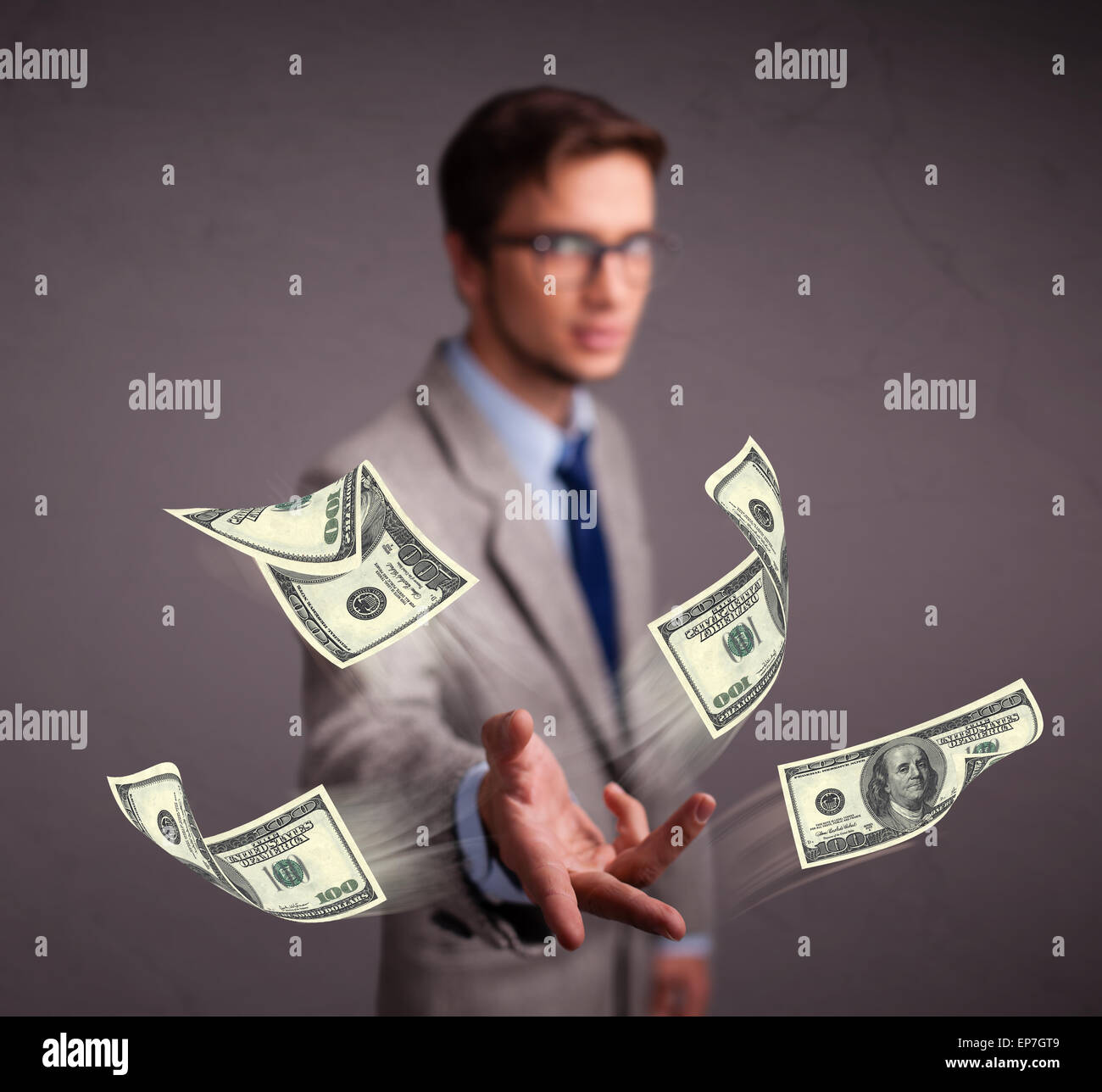 Young man throwing money Stock Photo - Alamy
