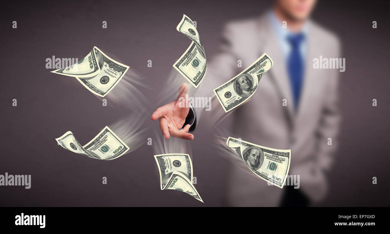 Young man throwing money Stock Photo - Alamy