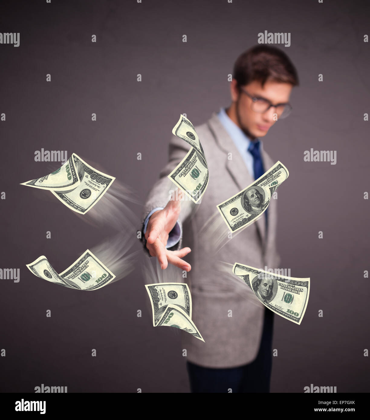Young man throwing money Stock Photo - Alamy