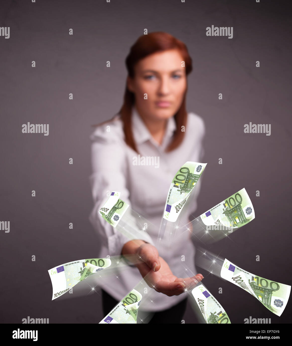 Pretty woman standing and throwing money Stock Photo - Alamy