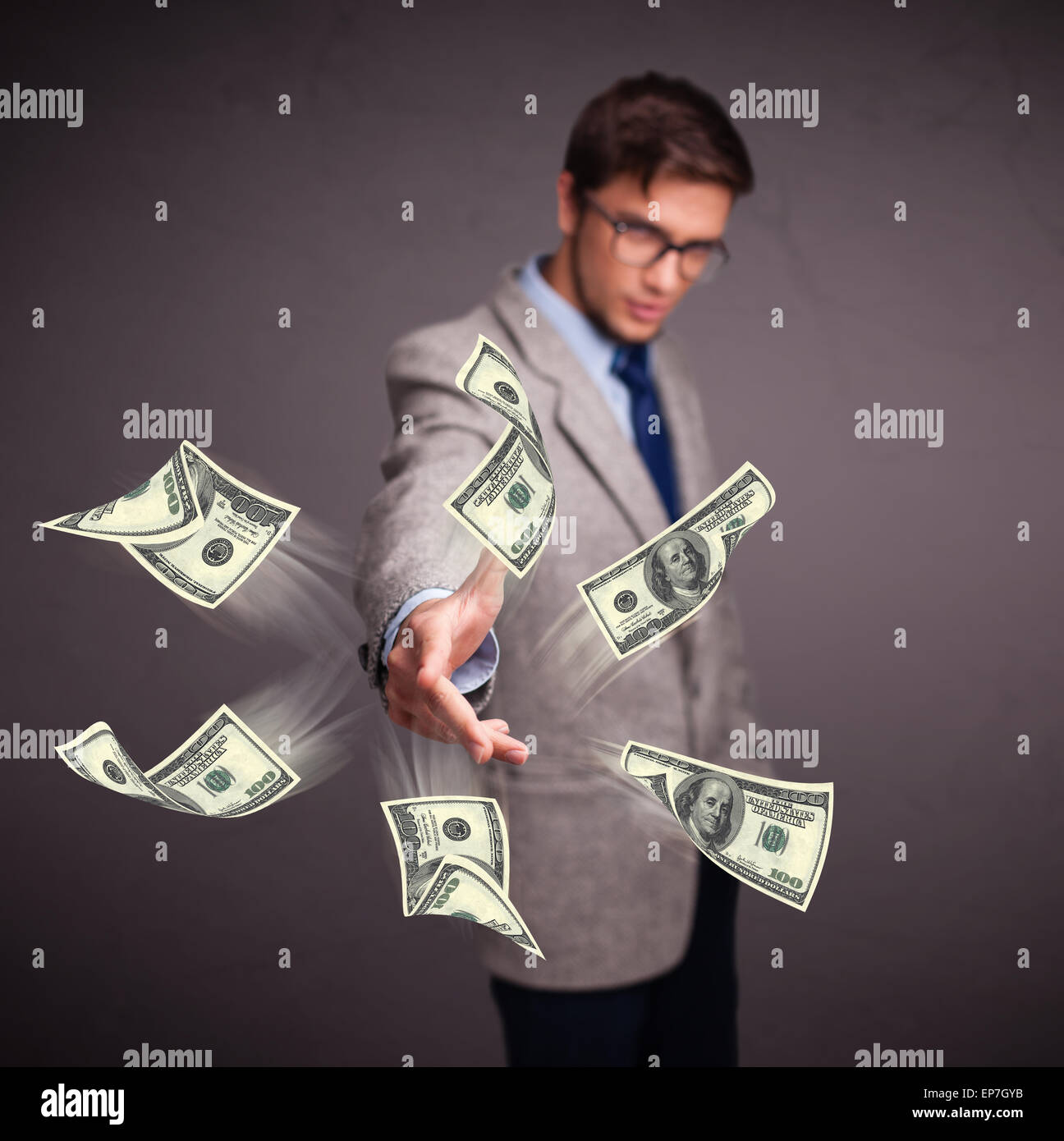 Young man throwing money Stock Photo - Alamy