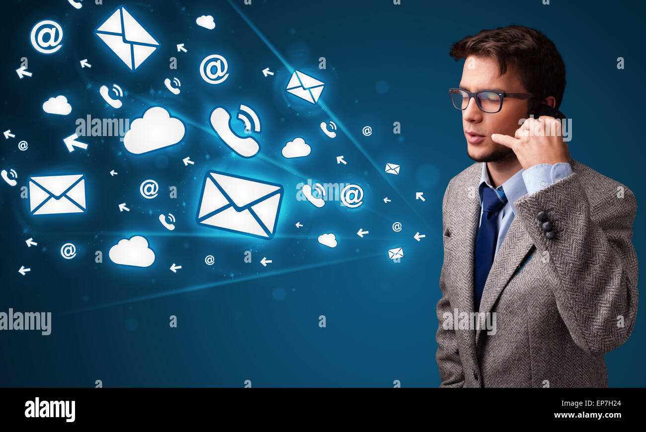 Young man making phone call with message icons Stock Photo - Alamy