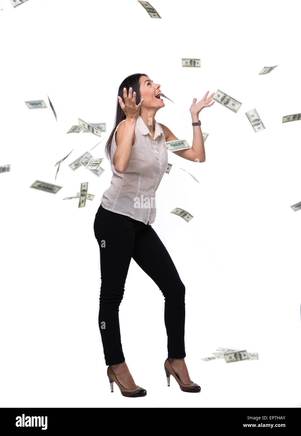 Full length portrait of a businesswoman under money rain isolated on a ...