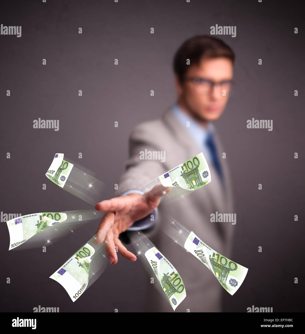 Young man standing and throwing money Stock Photo - Alamy
