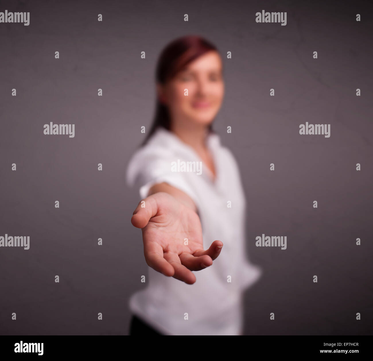 Pretty girl holding something Stock Photo - Alamy